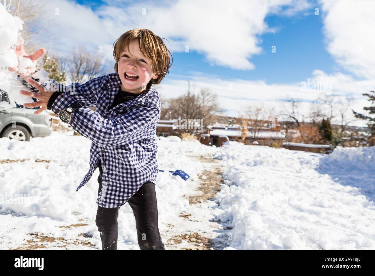 A six year old boy throwing a snowball Stock Photo - Alamy