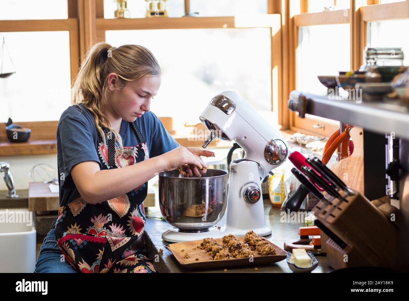 Teenage girl standing in kitchen hi-res stock photography and images ...