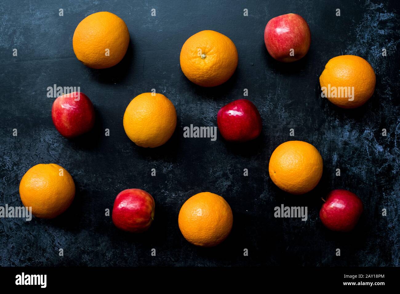 High angle close up of red apples and oranges on black background Stock ...