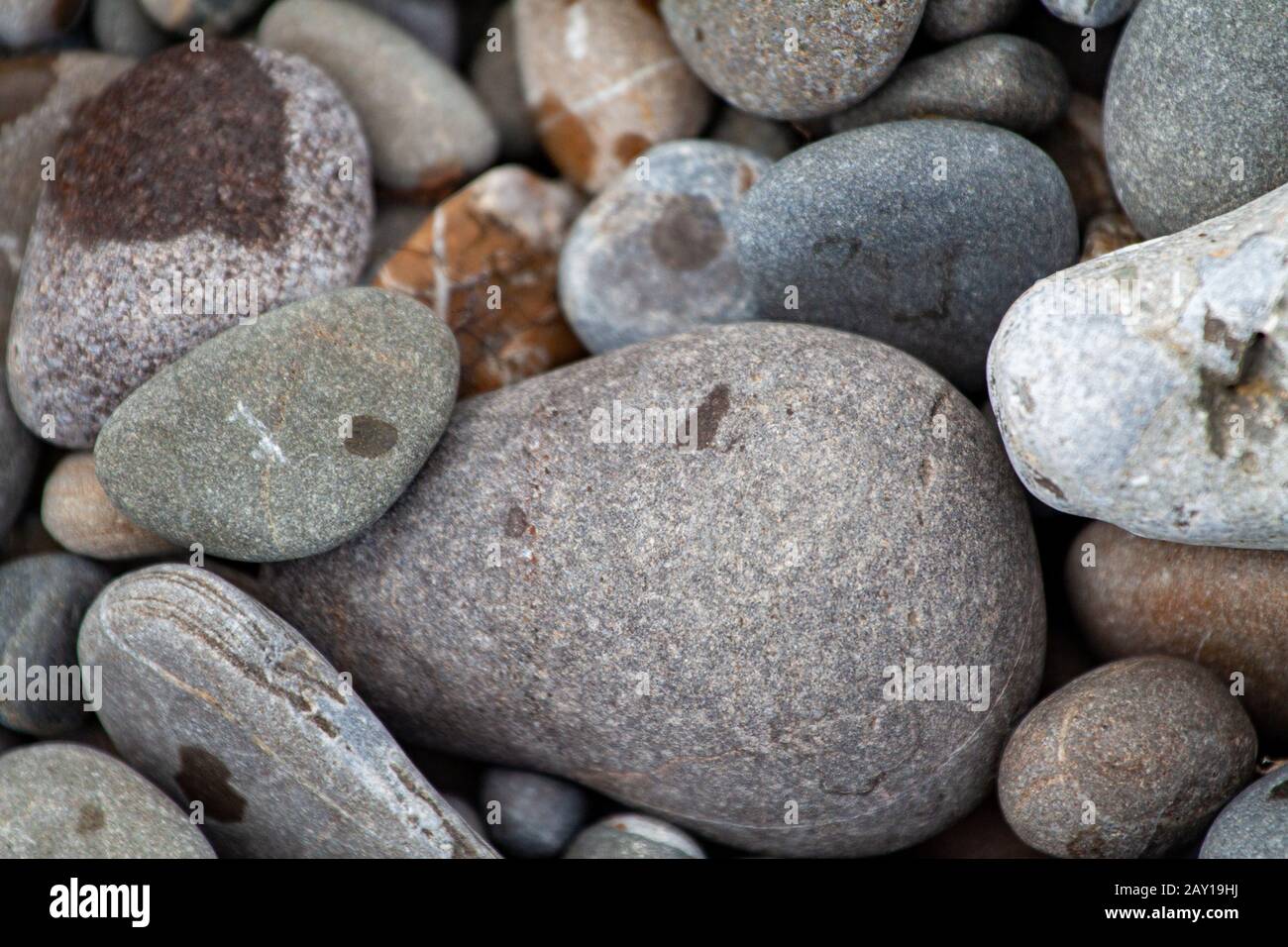 sea pebbles colored granite on the beach background stones. The shore ...