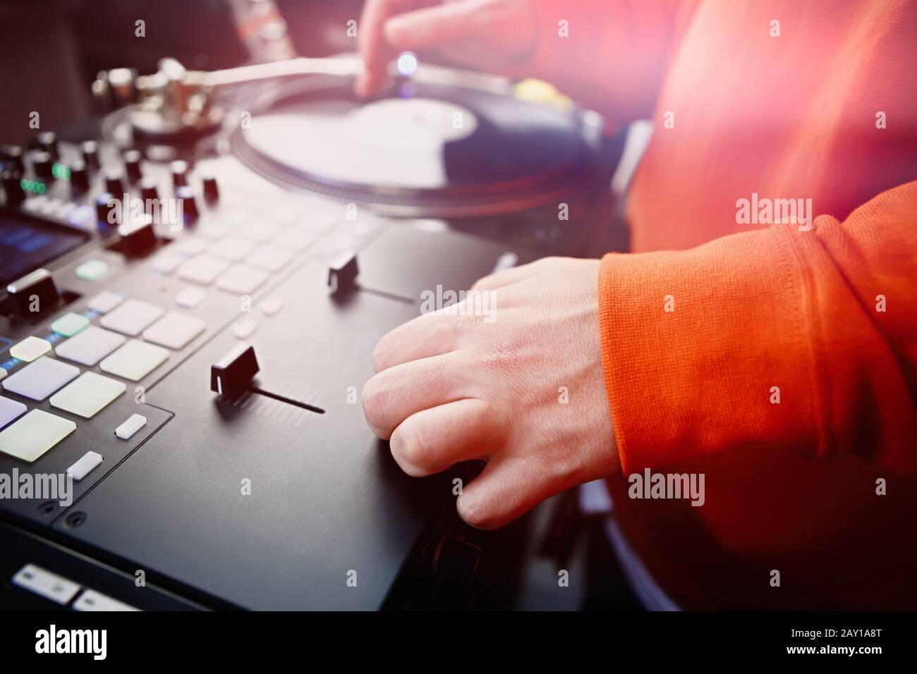 Hip hop disc jockey sracthes vinyl record on turntables.Professional dj ...