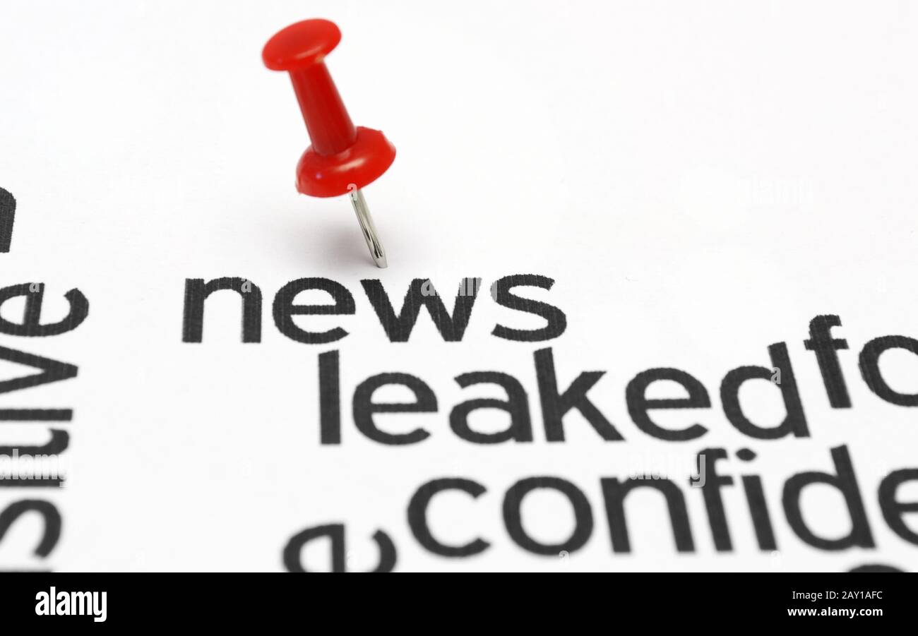 Push pin on news text Stock Photo - Alamy