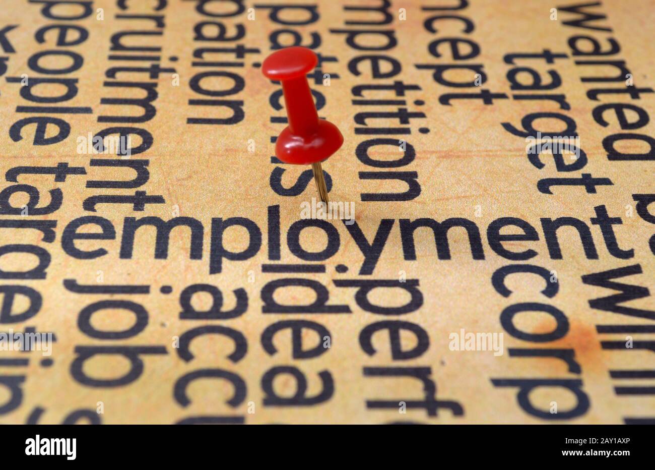 Push pin on employment text Stock Photo - Alamy