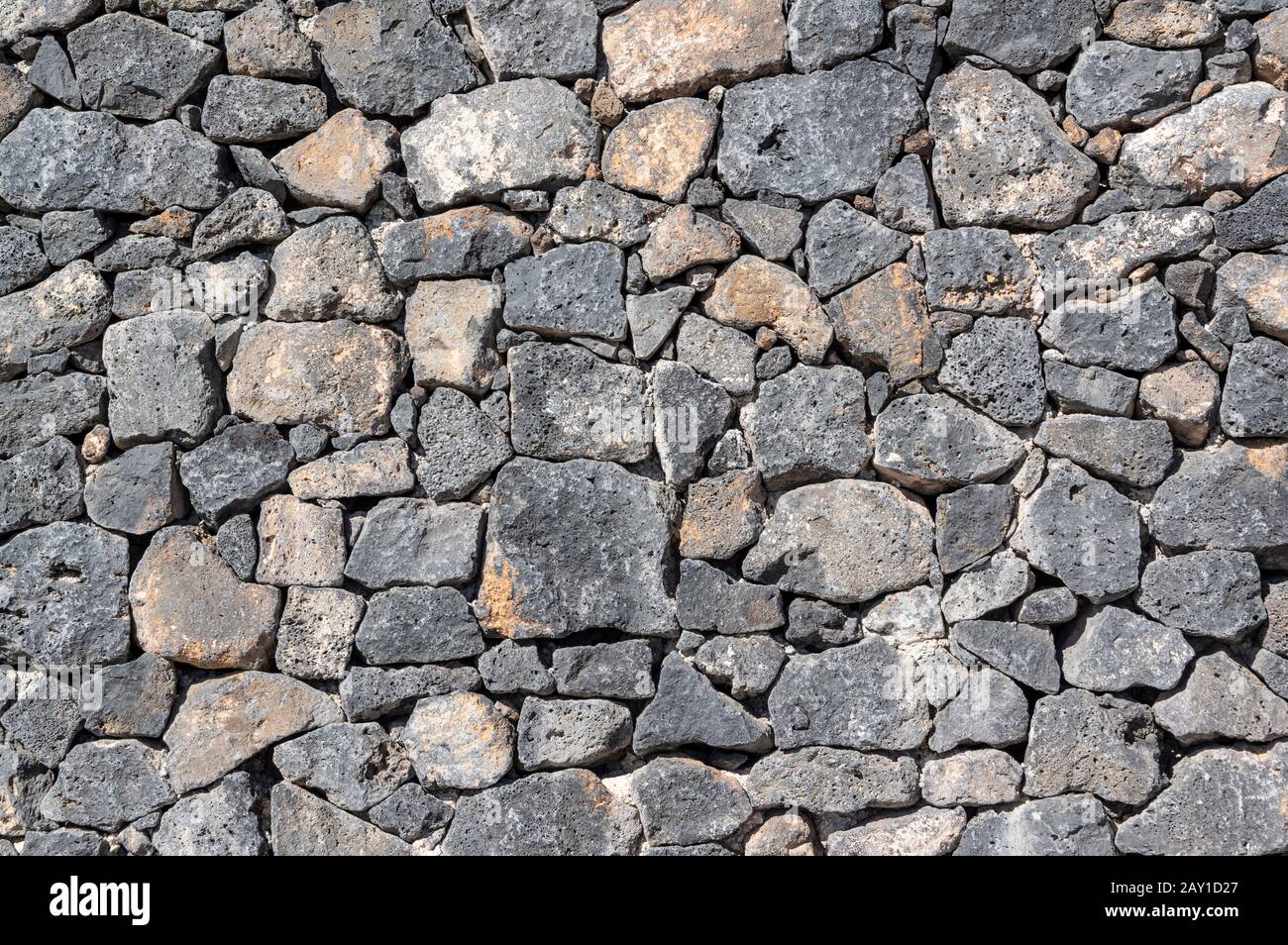 Texture of stone wall made of volcanic rocks Stock Photo - Alamy