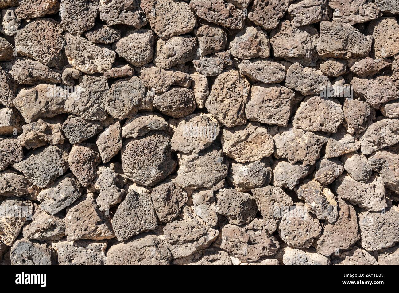 Texture of stone wall made of volcanic rocks Stock Photo - Alamy