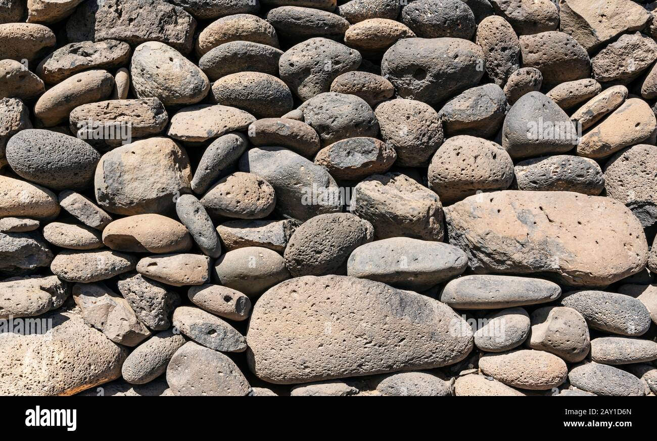 Texture of stone wall made of volcanic rocks Stock Photo - Alamy