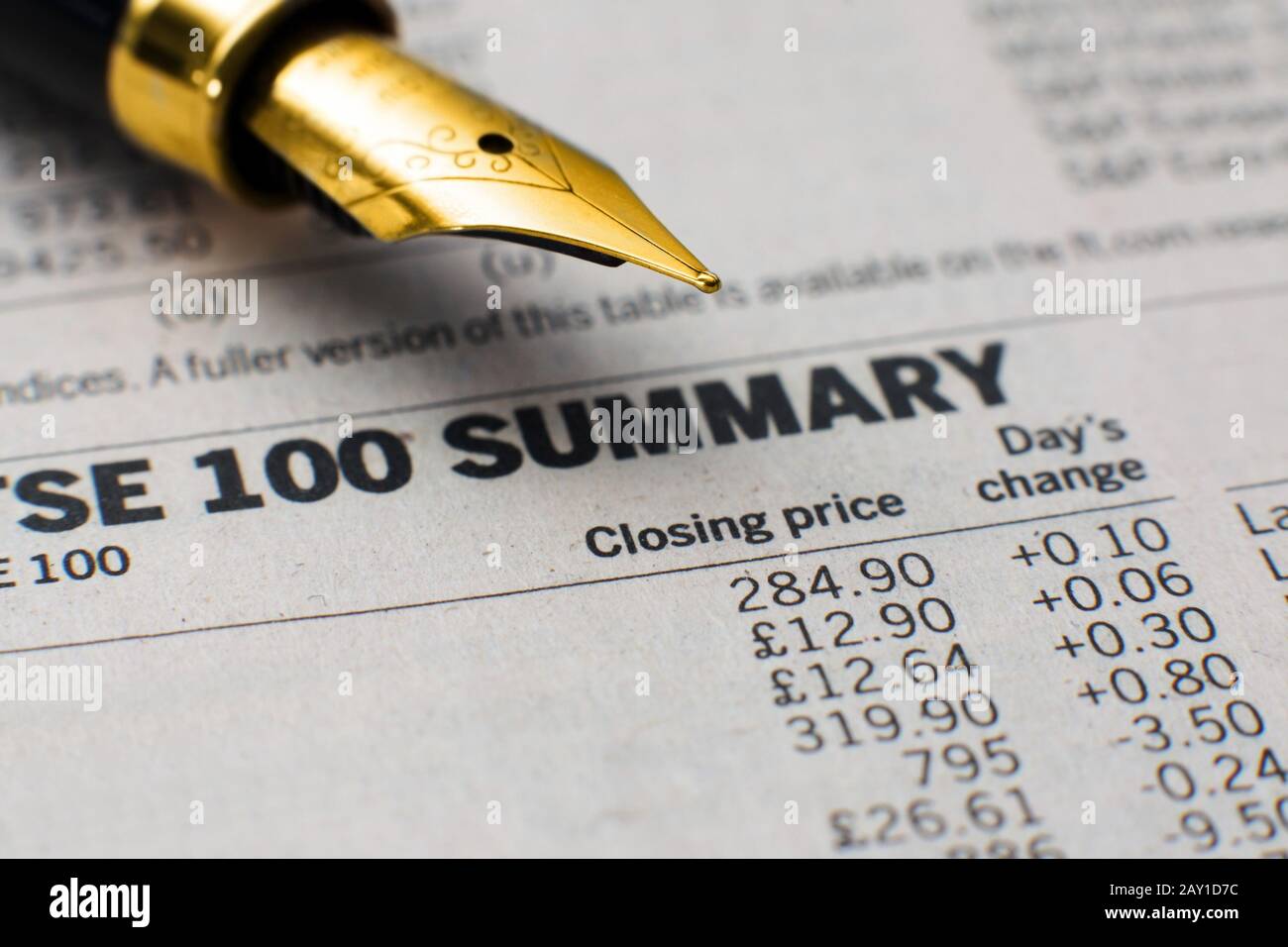 Fountain pen on stock market report Stock Photo - Alamy
