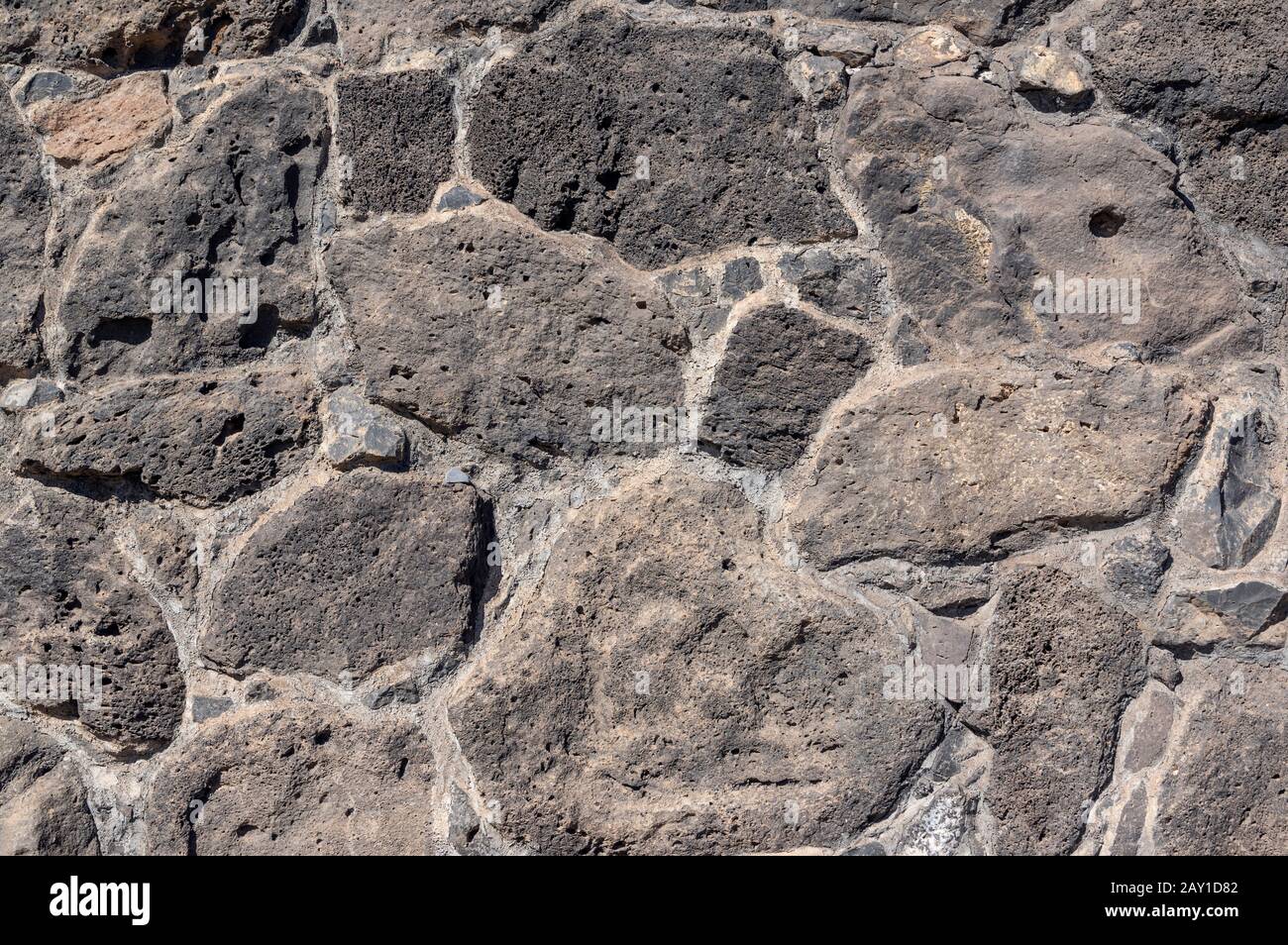 Texture of stone wall made of volcanic rocks Stock Photo - Alamy