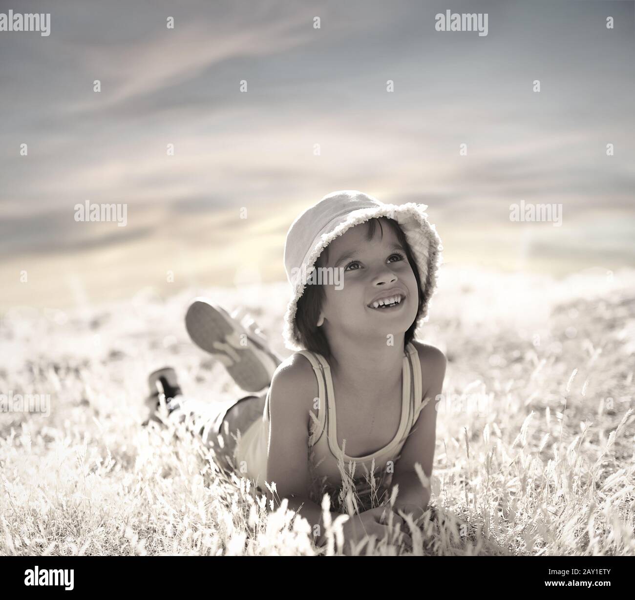 Happy kid lay on autumn grass Stock Photo - Alamy
