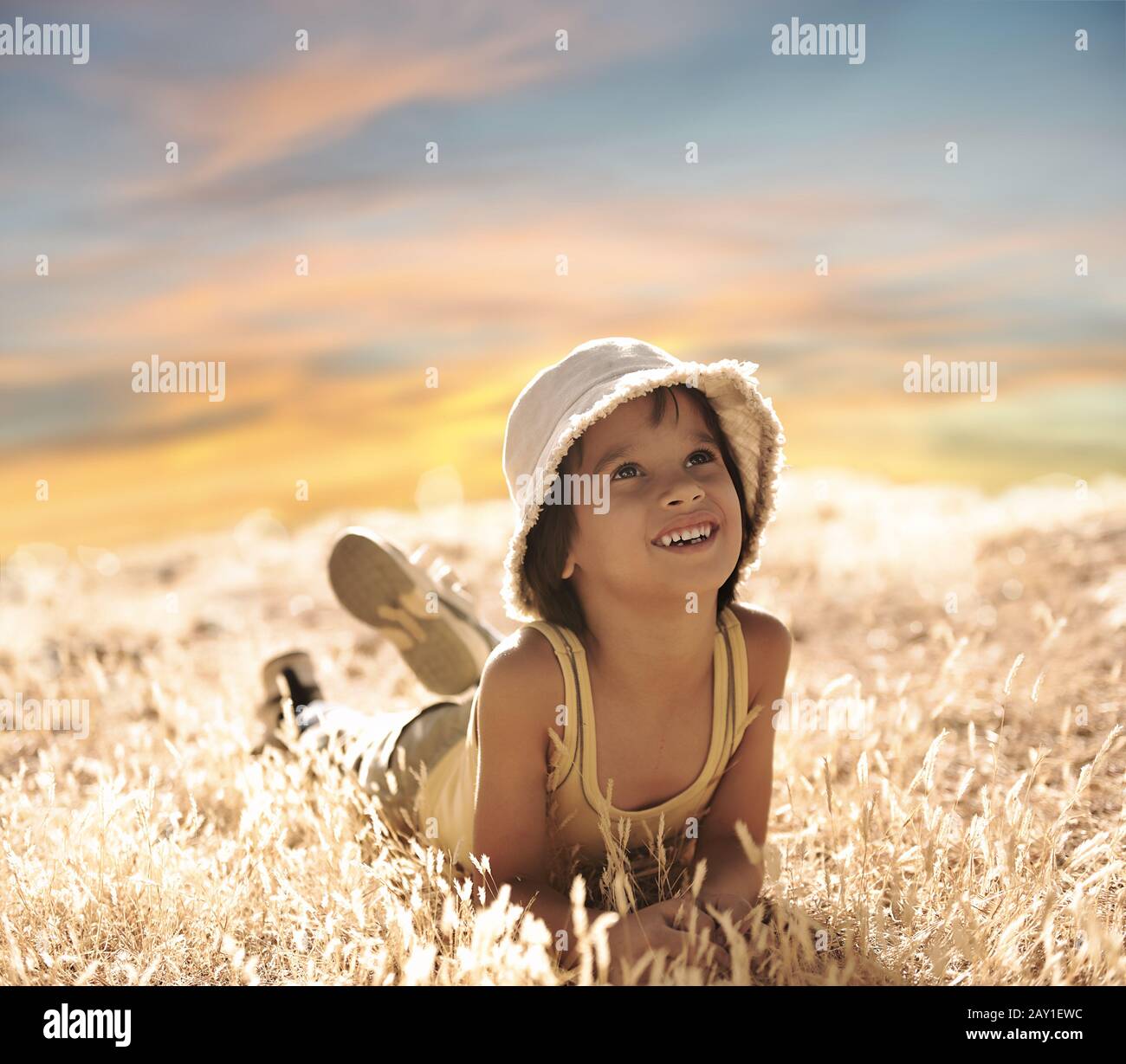 Happy boy laying on ground Stock Photo - Alamy