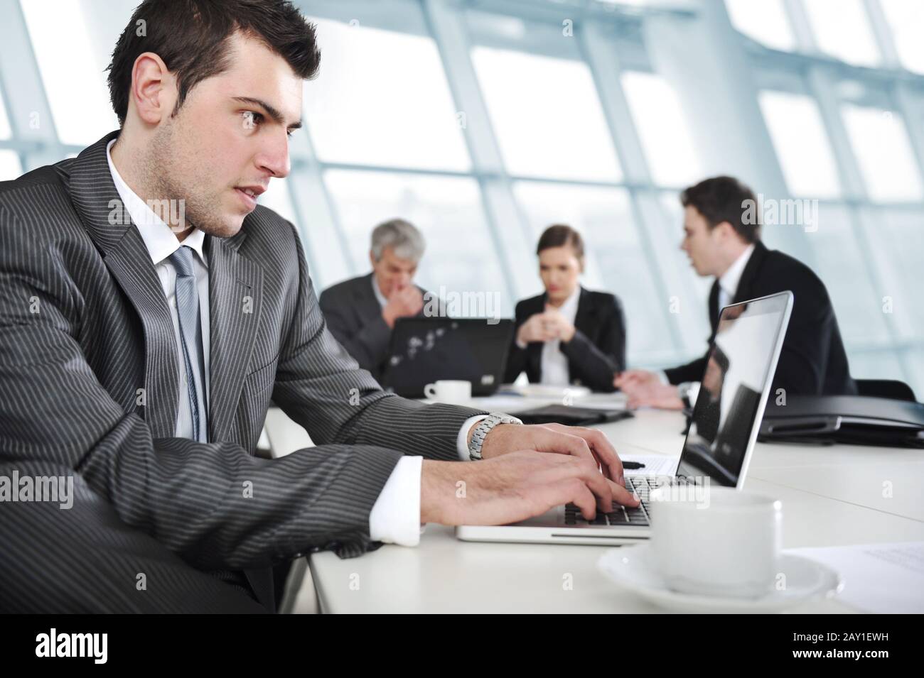 Typing report on laptop during the meeting Stock Photo - Alamy
