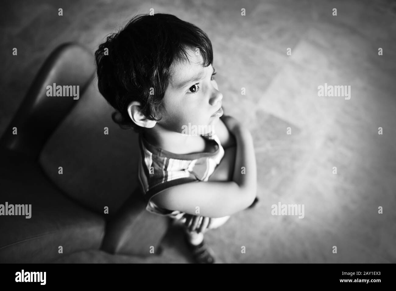 Angry boy in dark room, old style photography Stock Photo - Alamy