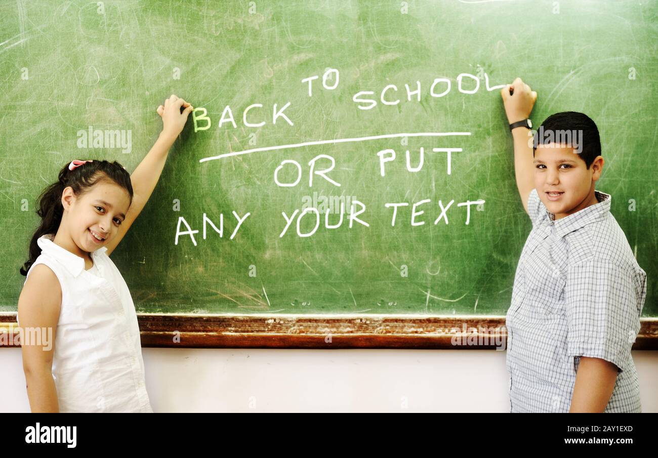 Two young students in class on board writing: GREAT COPYSPACE for you ...