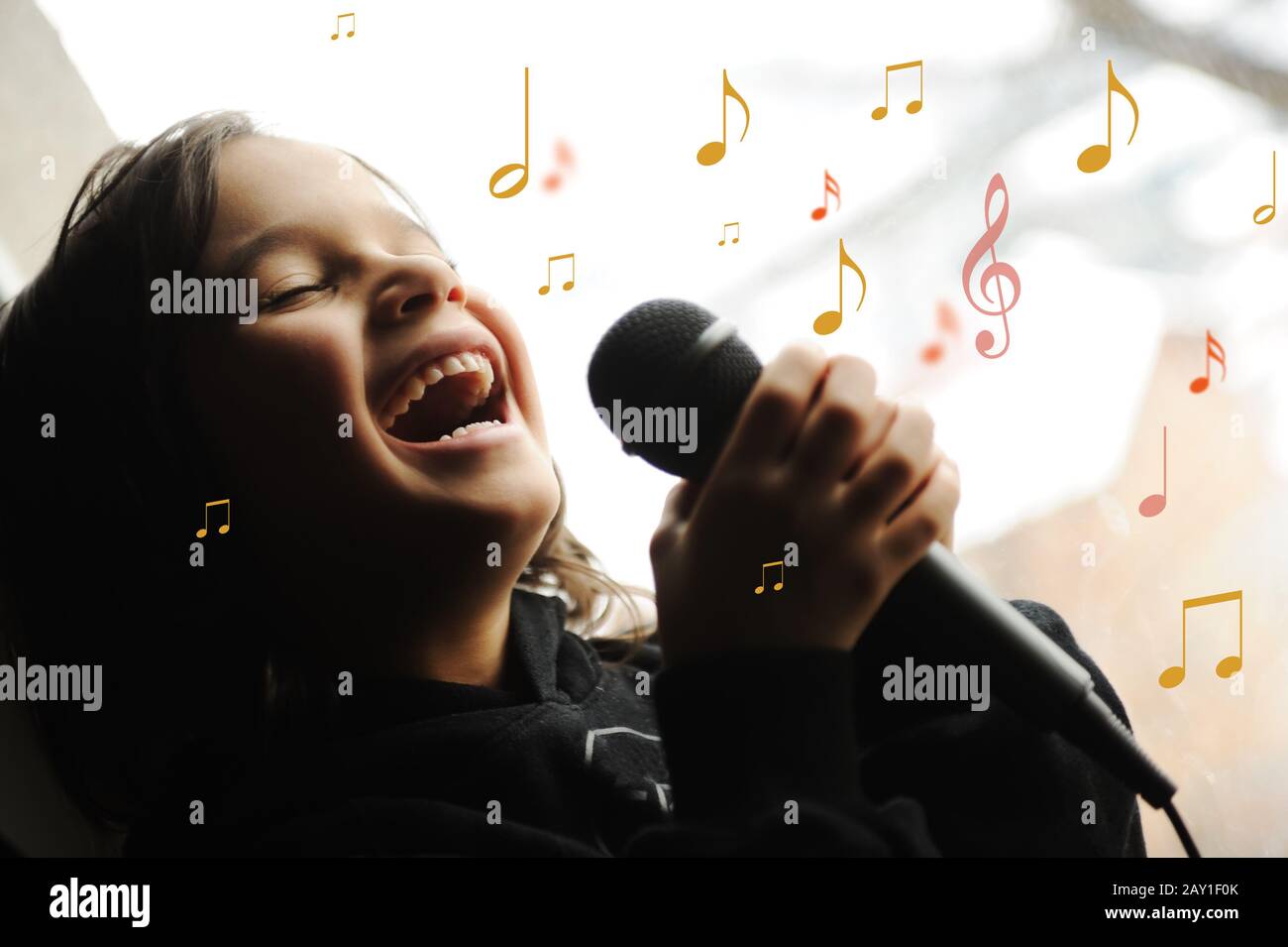Musician kid singing a song with microphone Stock Photo - Alamy