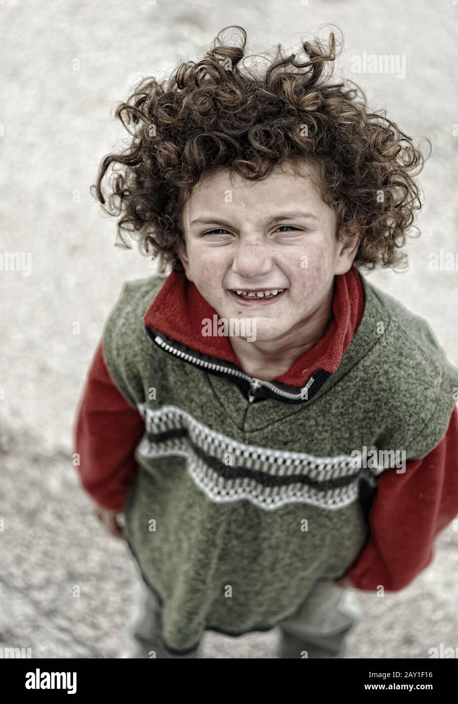 Poor dirty child on the street, long hair Stock Photo - Alamy