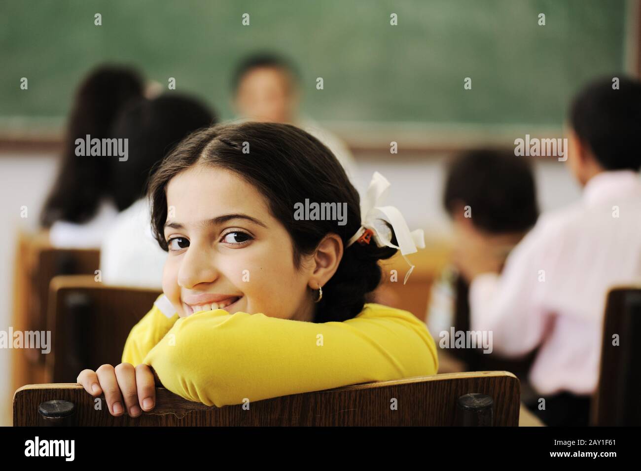 Beautiful little school girl in classroom Stock Photo - Alamy