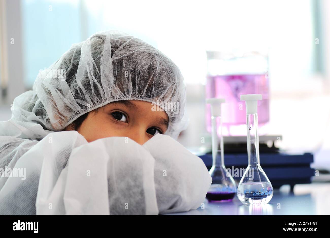 Smart cute little male child experimenting with test tubes in real ...