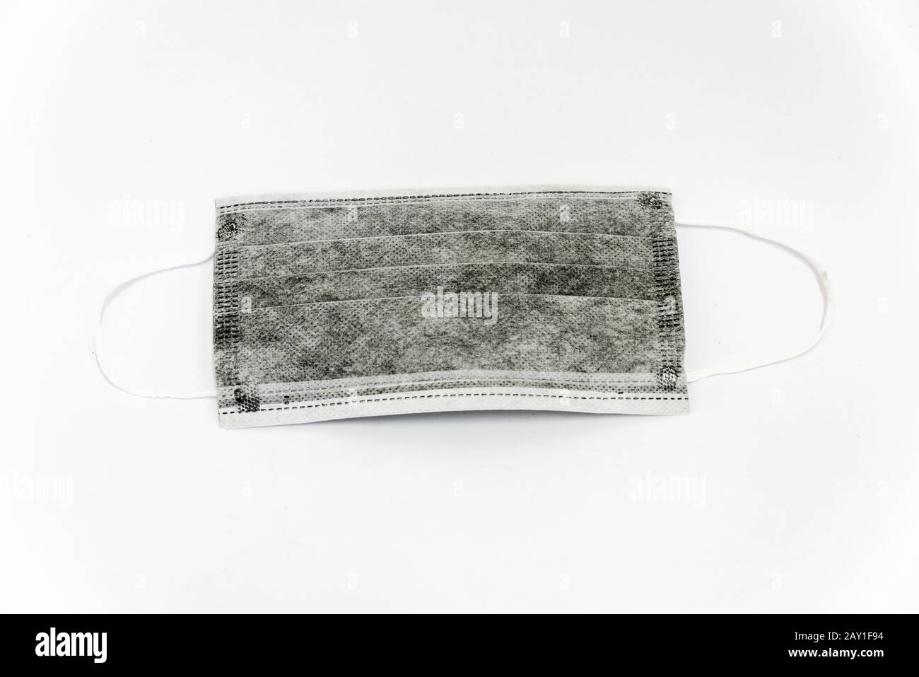 Activated carbon disposable fiber face masks with earloops isolated on ...