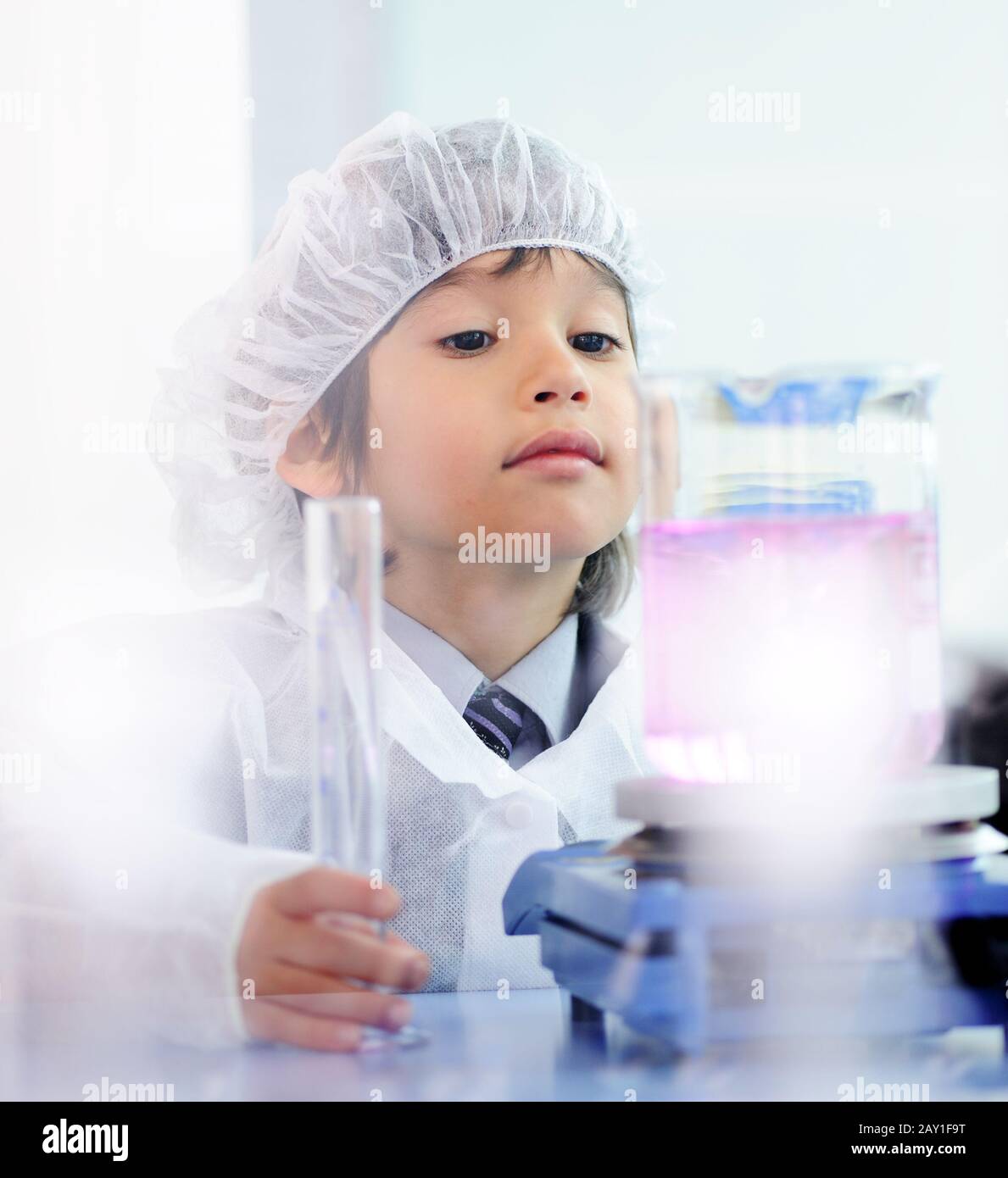 Smart cute little male child experimenting with test tubes in real ...
