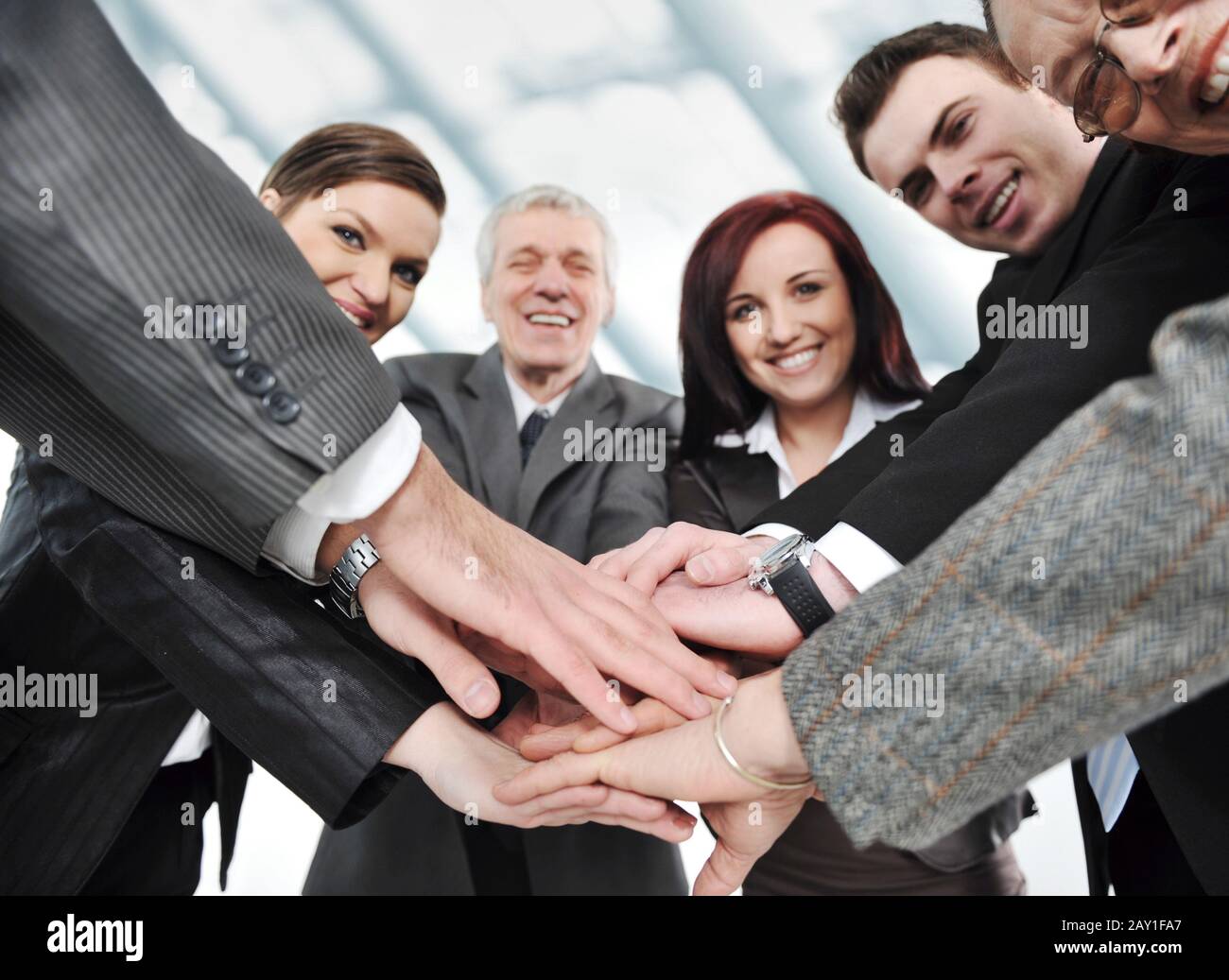 Group of happy smiling executives placing their hands together Stock ...