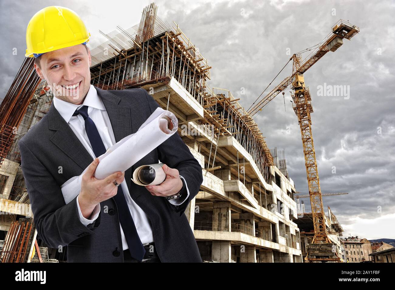 engineer builder with blueprint at construction site Stock Photo - Alamy