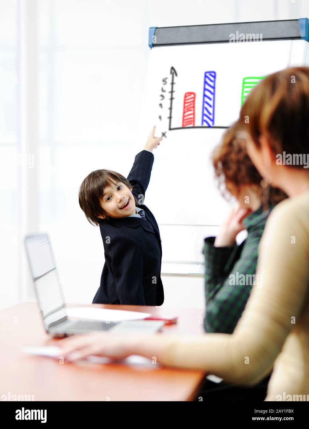 Genius kid on business presentation speaking to adults and giving them ...