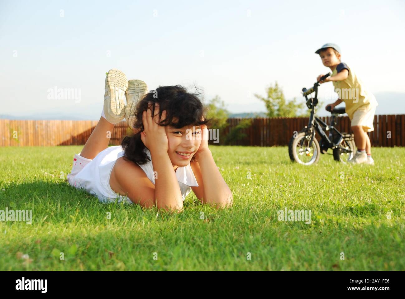 Happy children on beautiful green meadow Stock Photo - Alamy