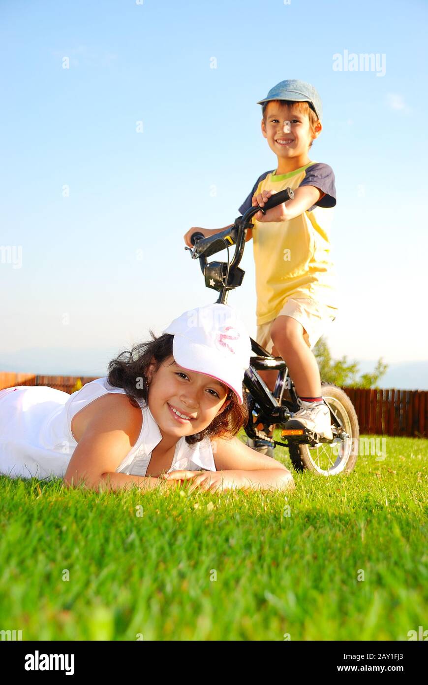 Happy children on beautiful green meadow Stock Photo - Alamy