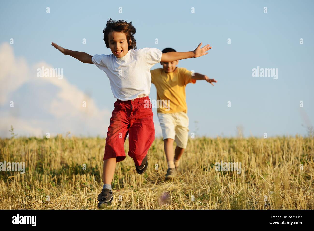 Two kids on meadow Stock Photo - Alamy
