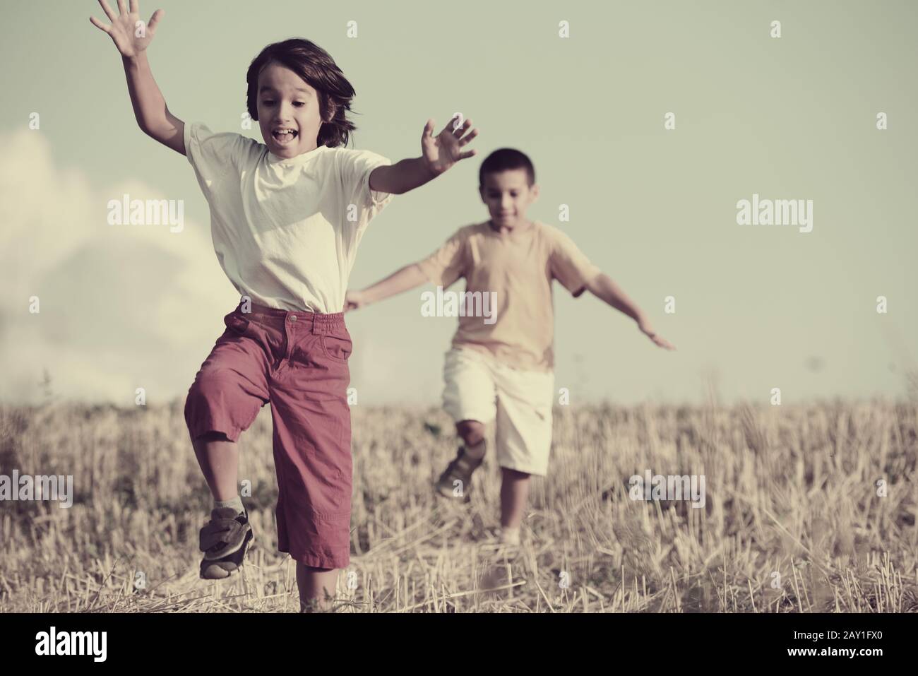 Two kids on meadow Stock Photo - Alamy
