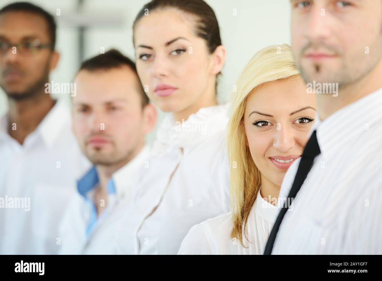 Successful business people in line Stock Photo - Alamy