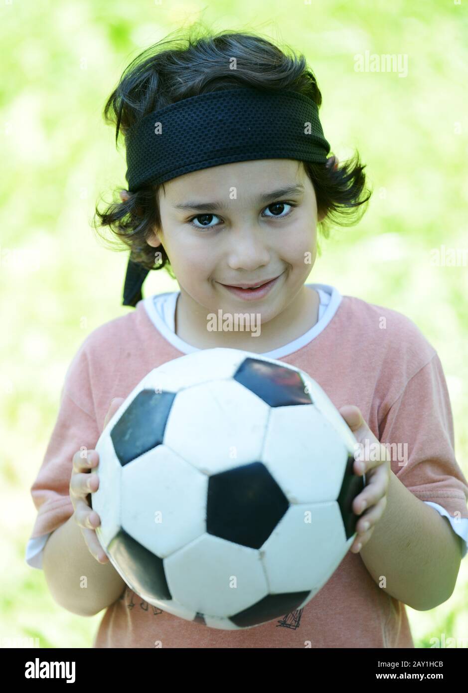 Young boy with football in park Stock Photo - Alamy