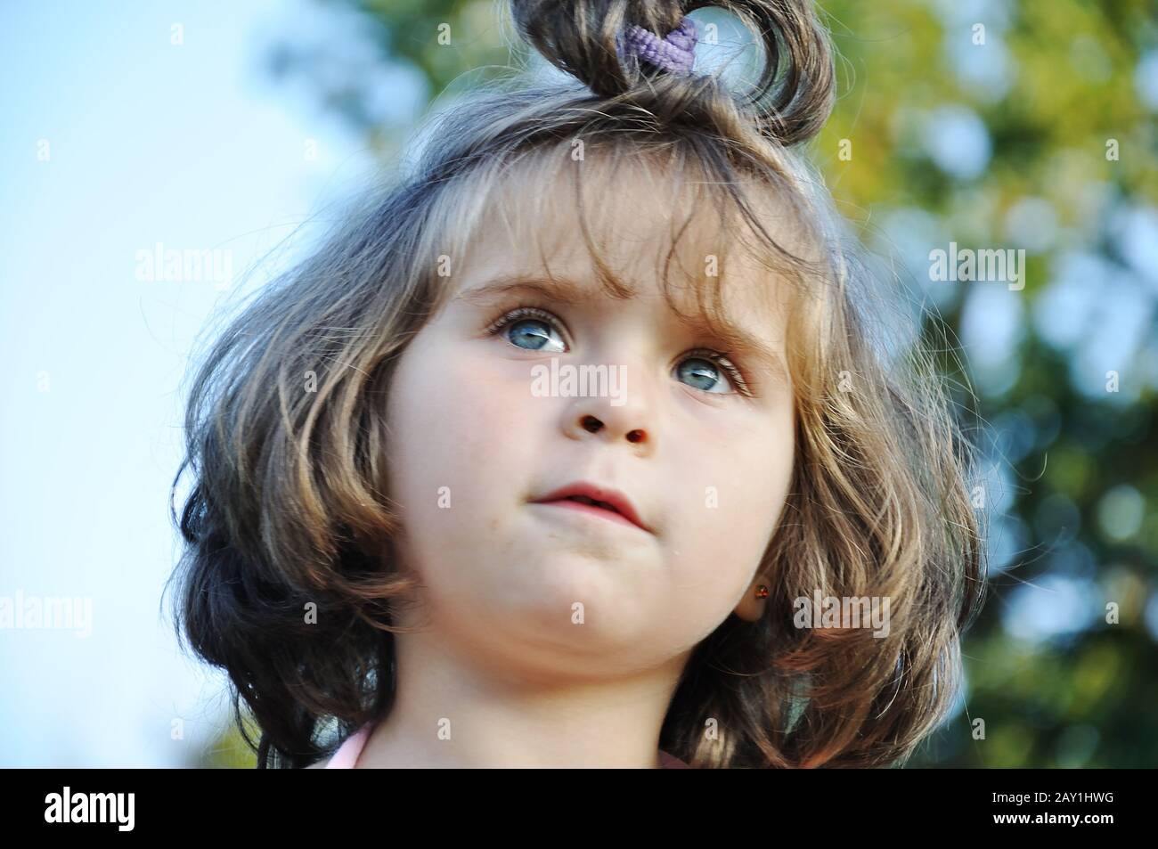 Happy beautiful child on ground outdoor Stock Photo - Alamy
