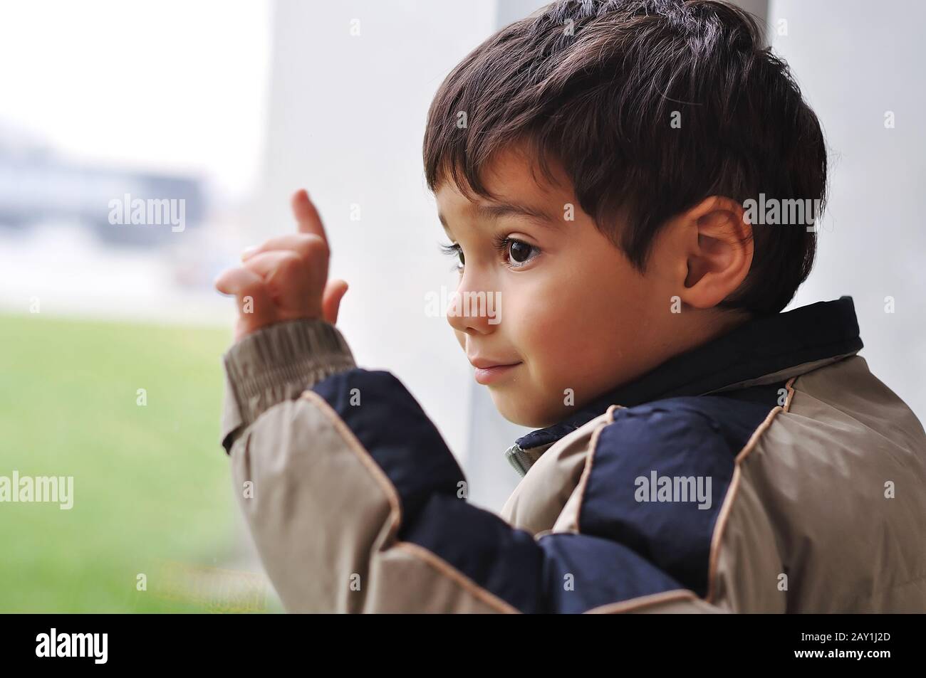 Little cute kid on glass window Stock Photo - Alamy