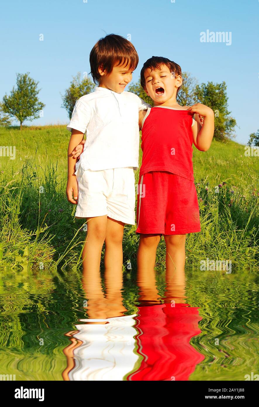 Two children on river Stock Photo - Alamy