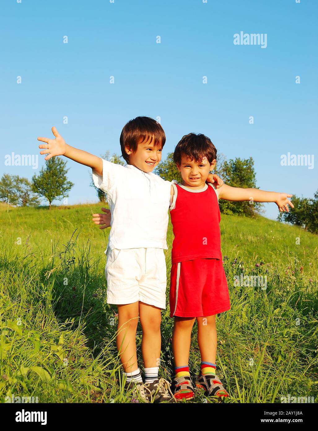 Little cute children on beautiful green field Stock Photo - Alamy