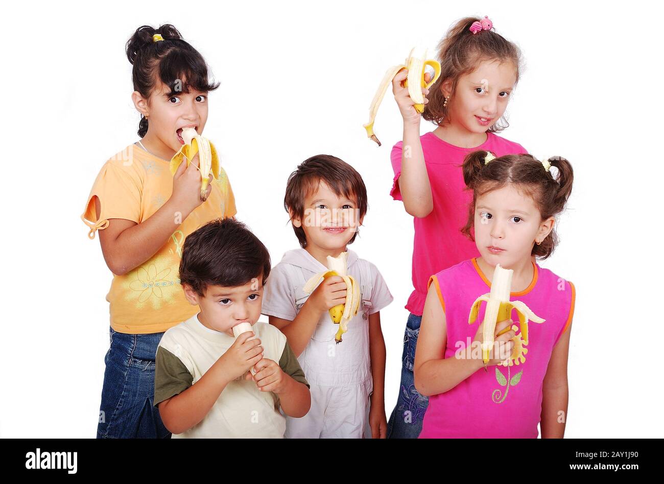 Group of children eating banana isolated Stock Photo - Alamy