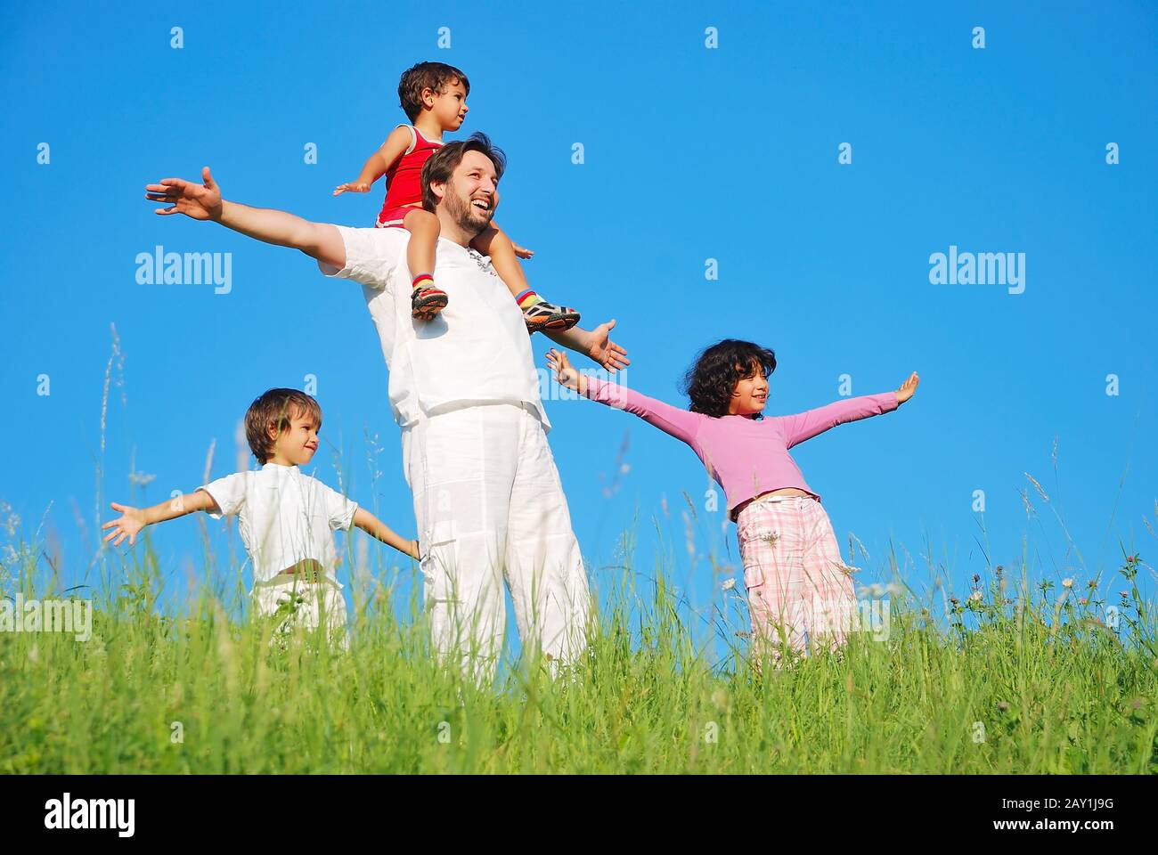 Happy family with four members on beautiful scene in nature Stock Photo ...