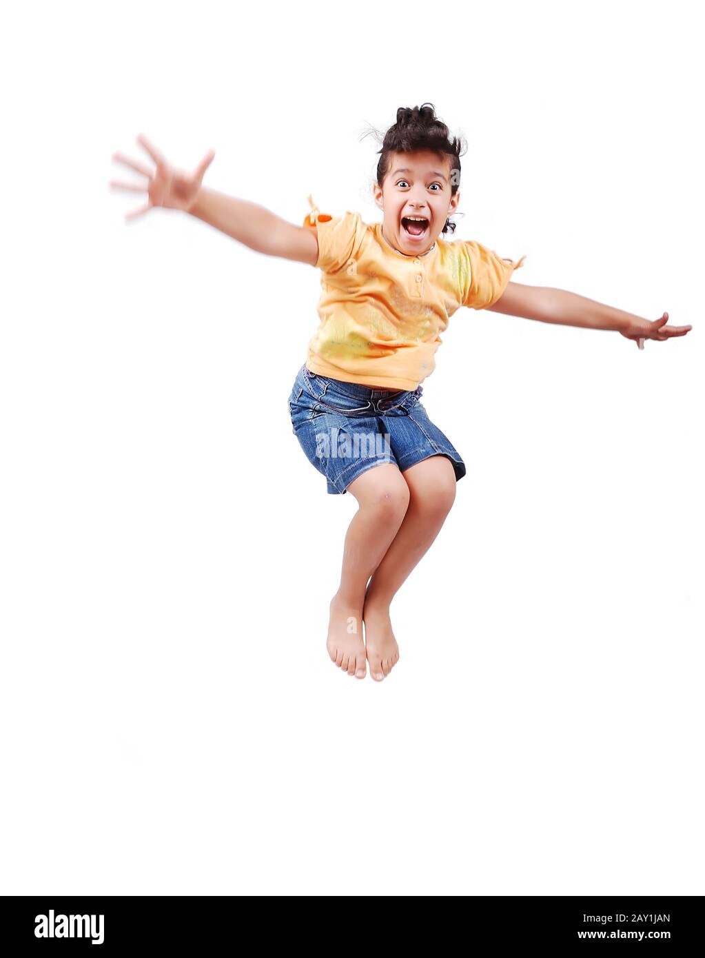 Happy cute girl in white clothes is jumping isolated Stock Photo - Alamy