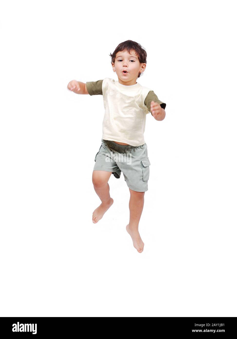 Happy little child in white clothes is jumping isolated Stock Photo - Alamy