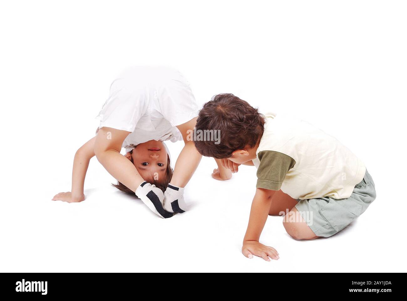 Two cute kids playing together isolated in white Stock Photo - Alamy