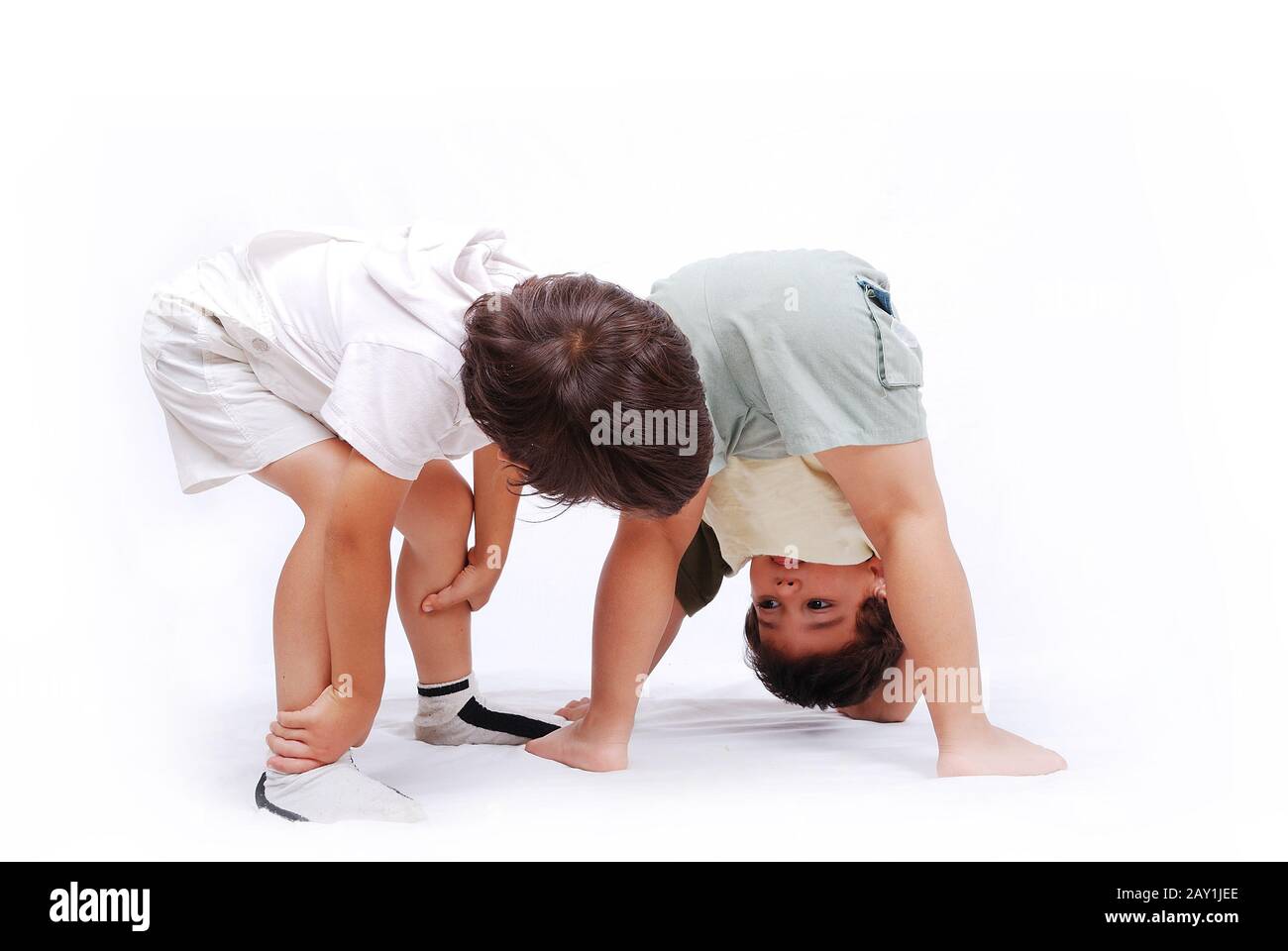 Two cute kids playing together isolated in white Stock Photo - Alamy