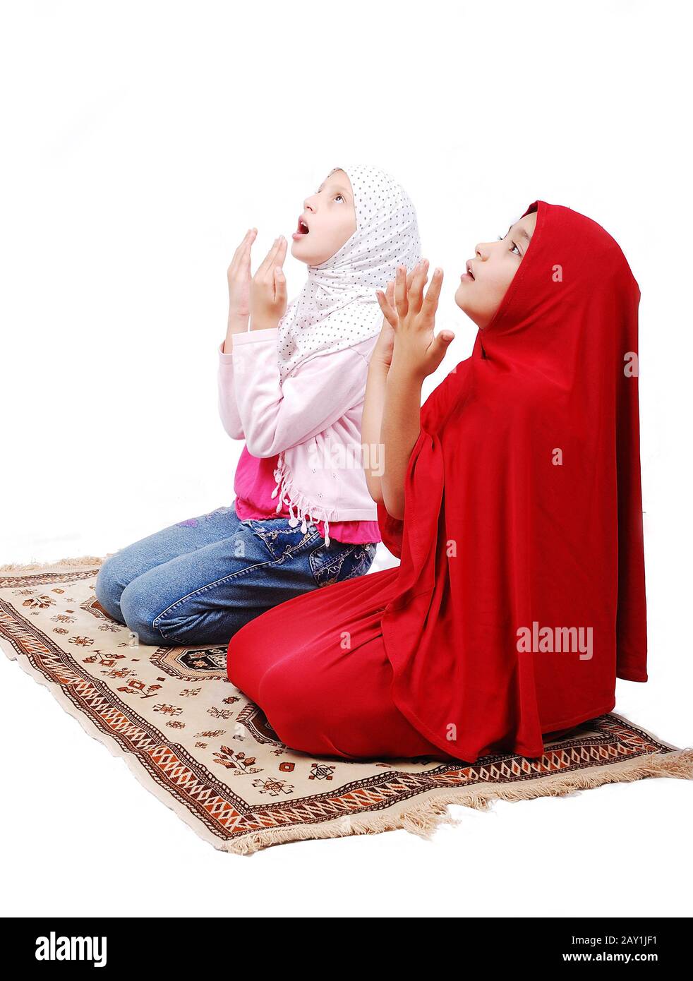A young muslim girls in traditional clothes praying Stock Photo - Alamy