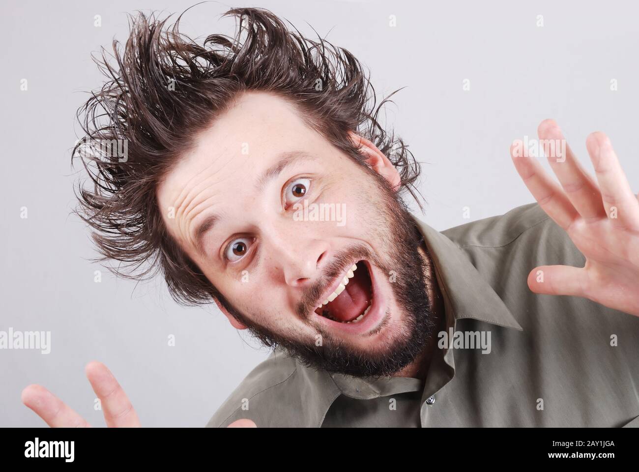 crazy young businessman facial expression Stock Photo - Alamy