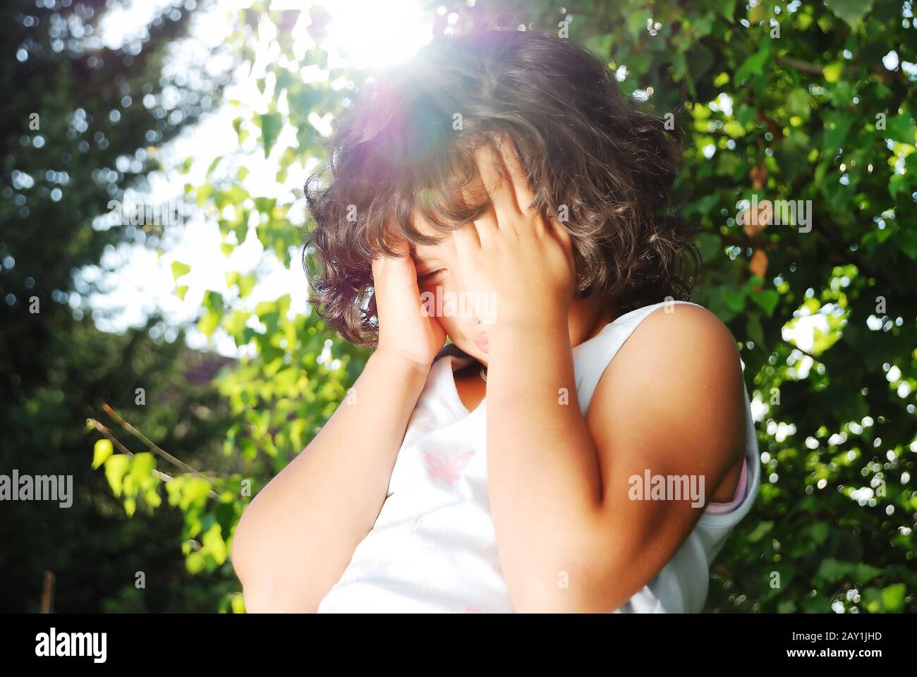 Girl crying with hands on face Stock Photo - Alamy