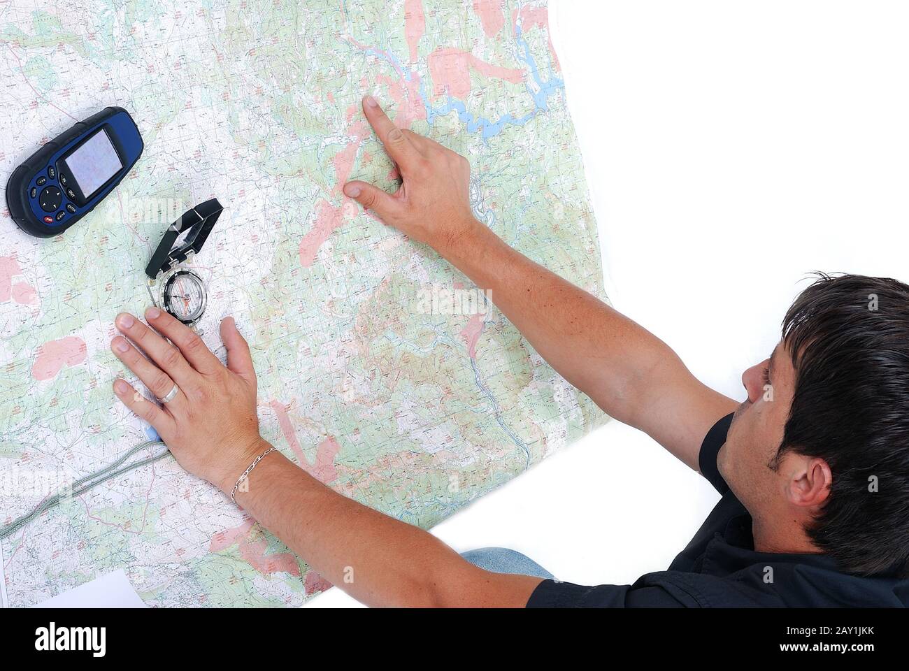 Man sitting and looking at maps in his hands Stock Photo - Alamy