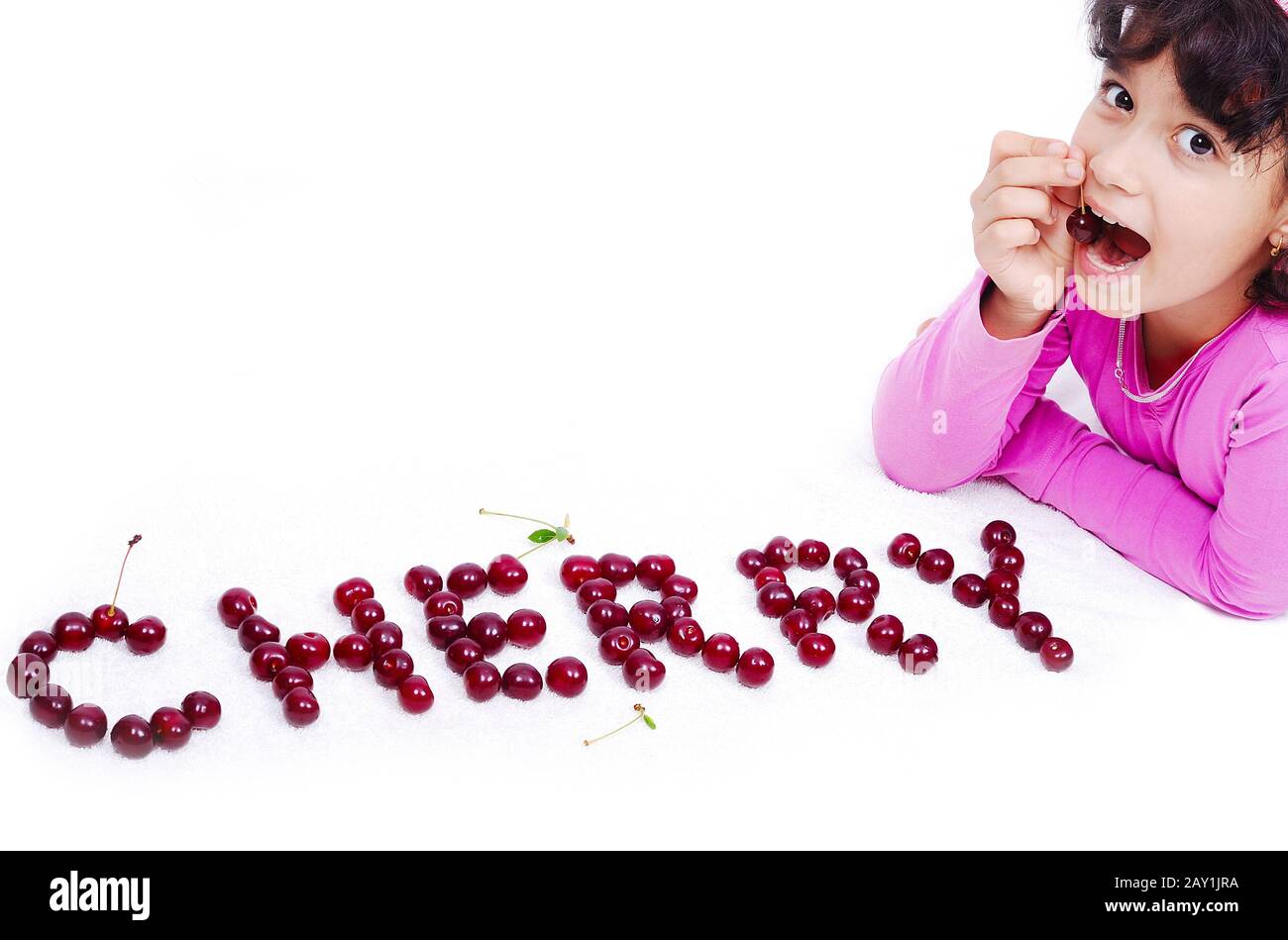 Cute girl is laying on ground with cherry note Stock Photo - Alamy
