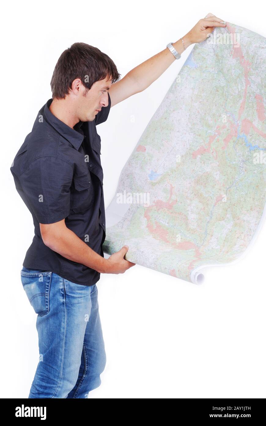 Man standing and looking at maps in his hands Stock Photo - Alamy