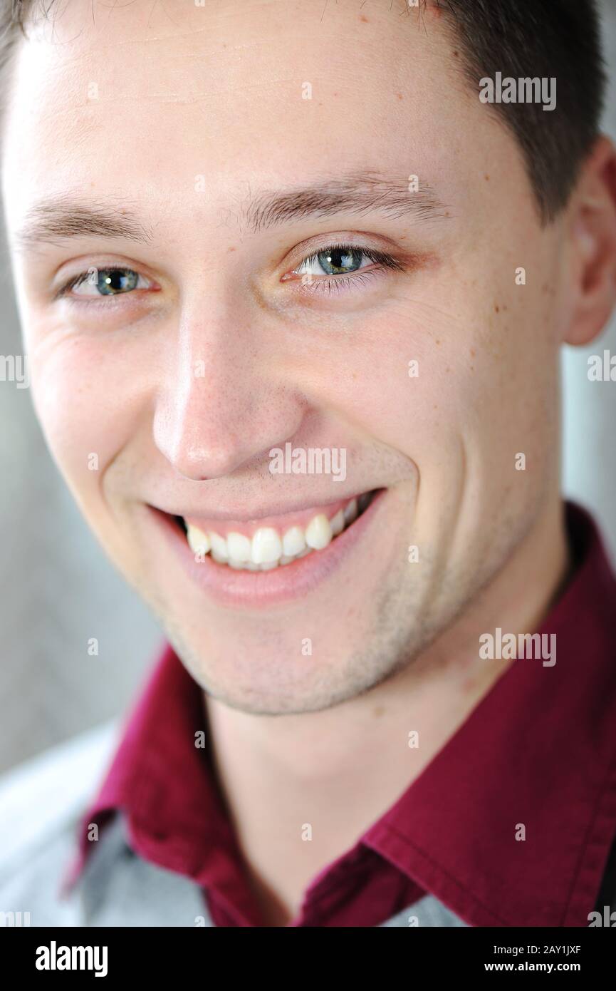 Portrait of young man smiling Stock Photo - Alamy