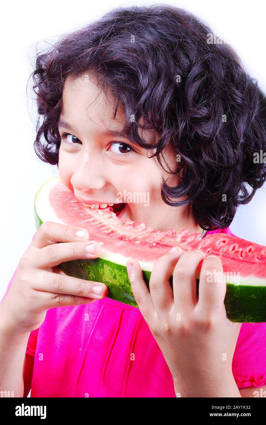 A beautiful girl eating water melon and smiling Stock Photo - Alamy